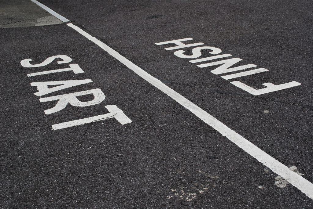 White painted start and finish lines on black tarmac | Survey & Ballot ...
